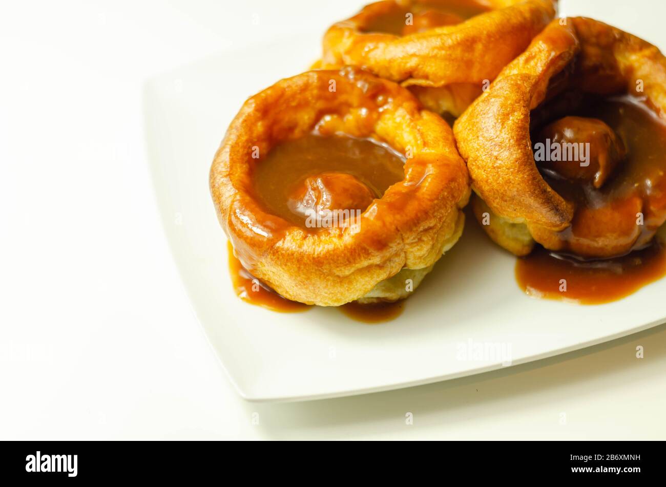 Traditional English Yorkshire pudding with meatballs and thick gravy ...