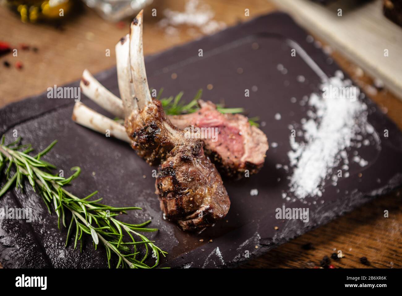 Grilled lamb chops served with a branch of rosemary Stock Photo - Alamy