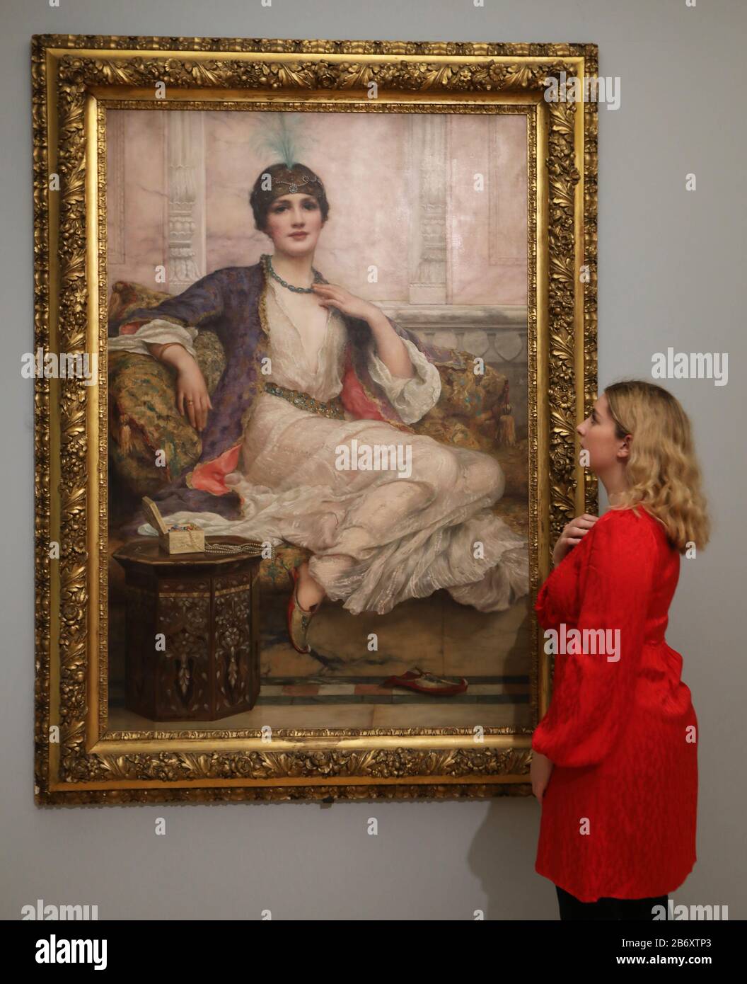 A gallery assistant views the painting Three Figures: Pink and Grey by ...