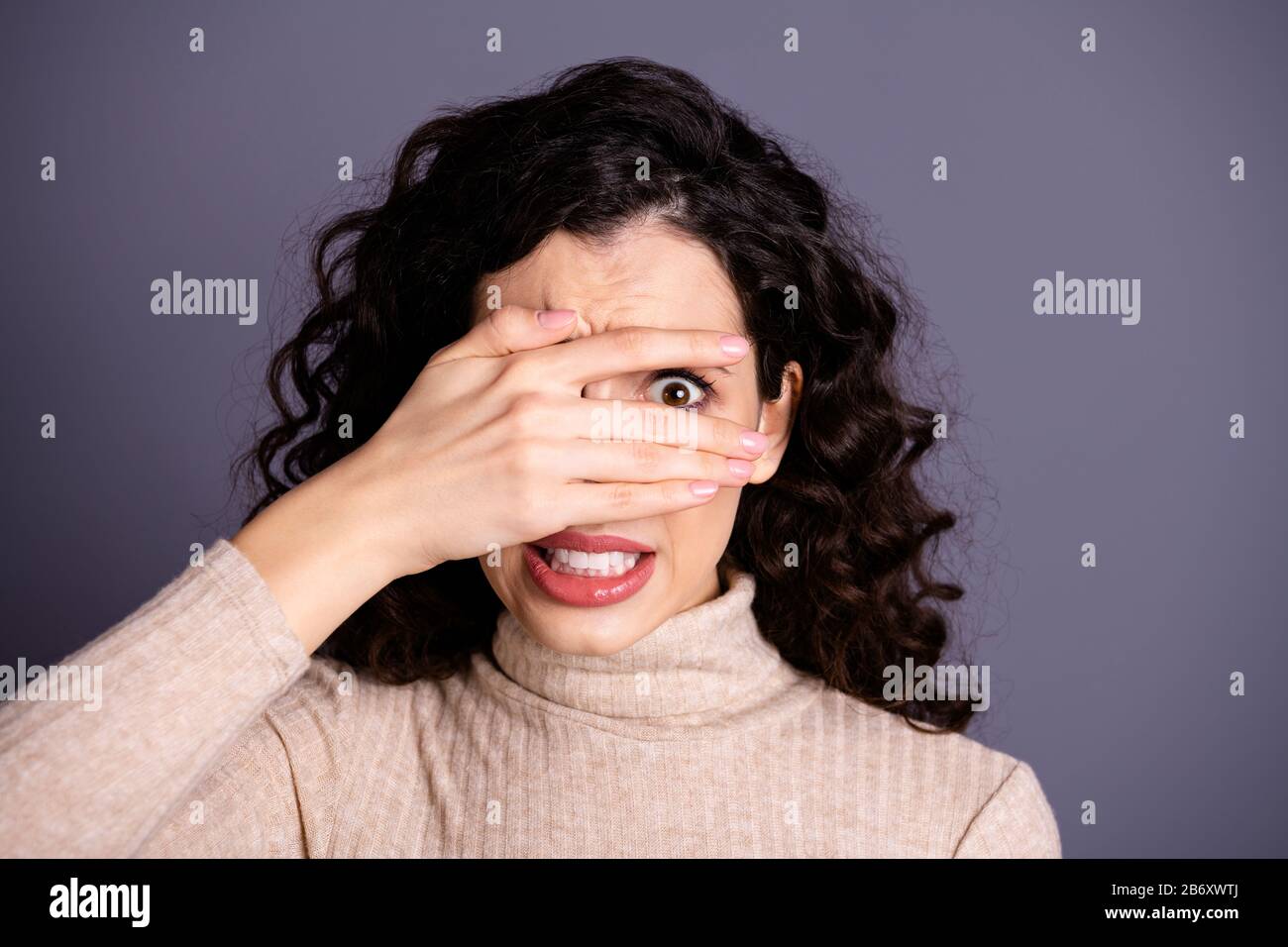 Hiding face behind fingers hi-res stock photography and images - Alamy