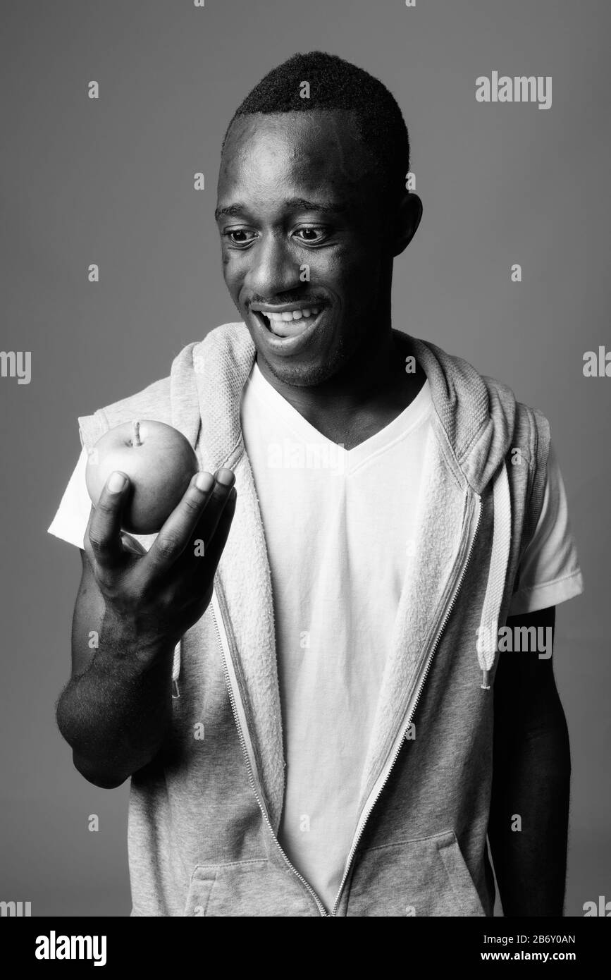 Portrait of young African man against gray background Stock Photo - Alamy