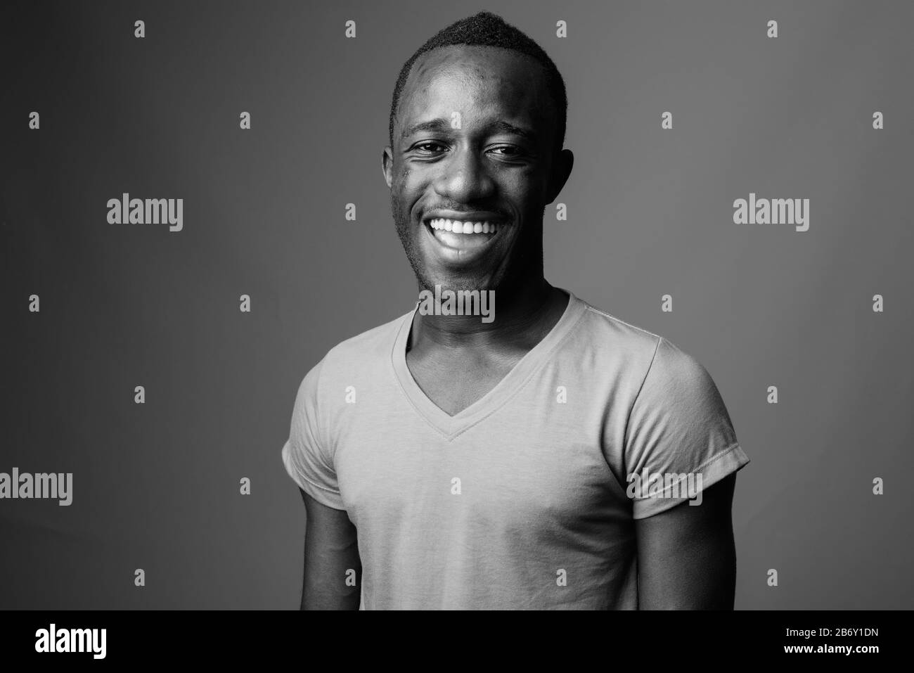 Portrait of young African man against gray background Stock Photo - Alamy