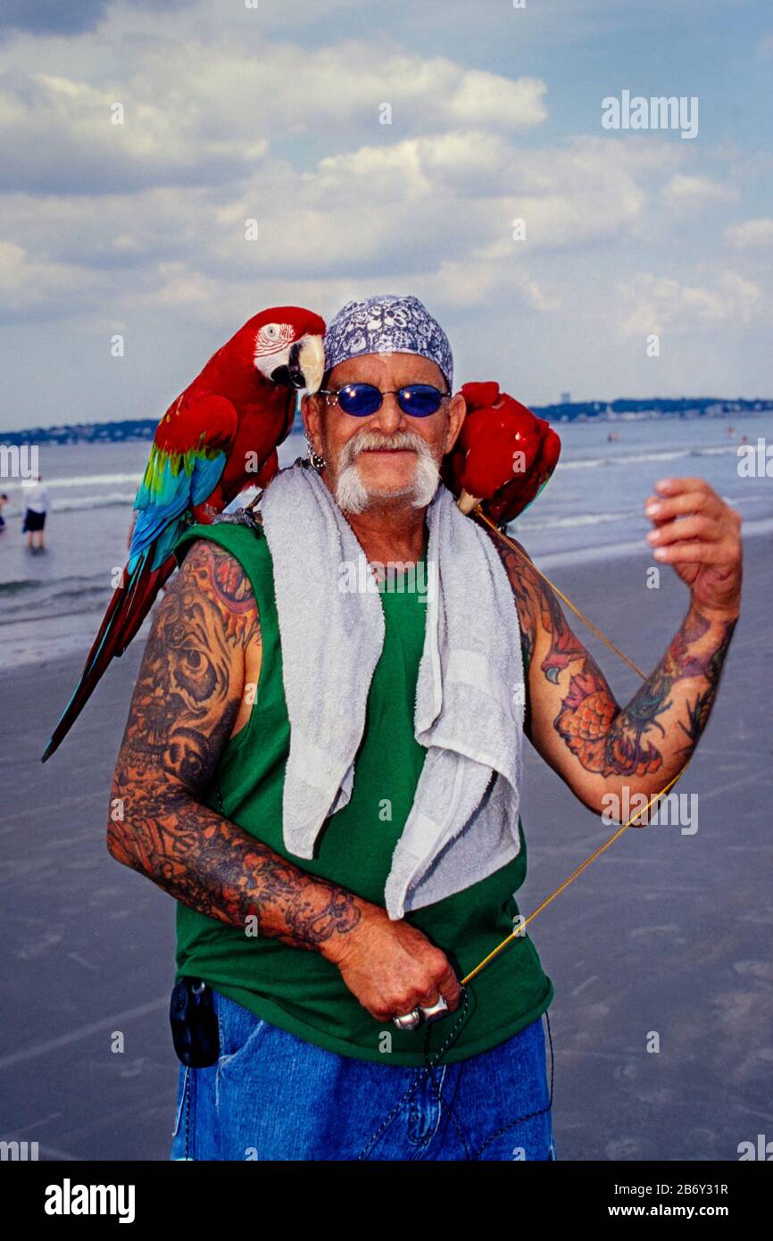 A man who looks somewhat like a modern-day pirate walks with two bright ...