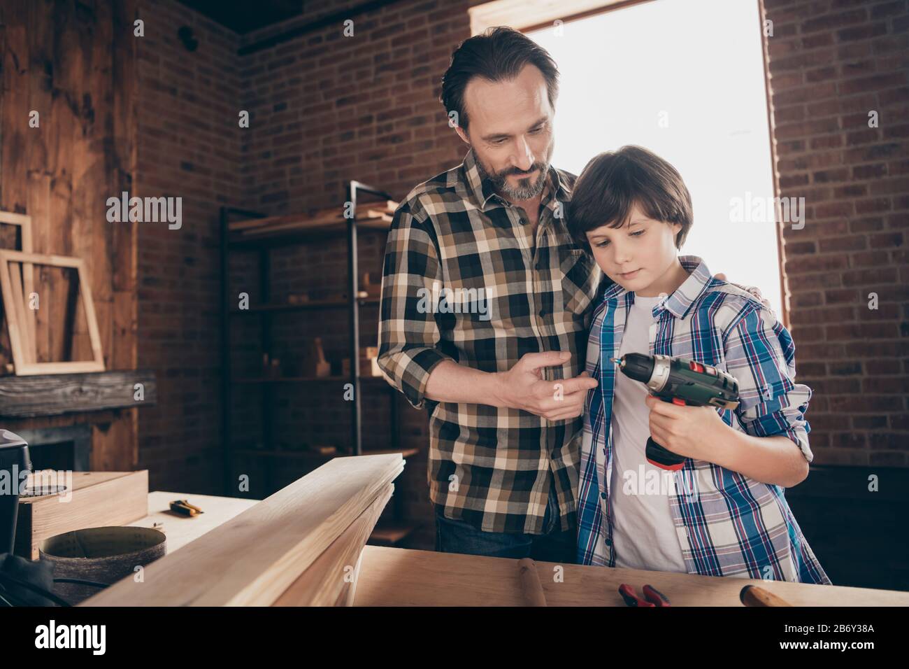 Portrait of two nice person focused concentrated woodworkers master ...