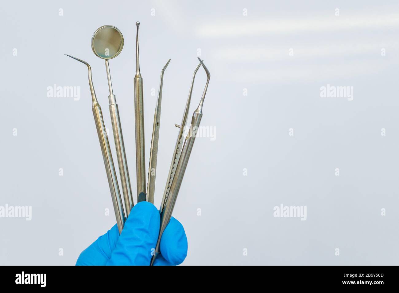 Dental tools in the hand of a doctor. Copy space Stock Photo - Alamy