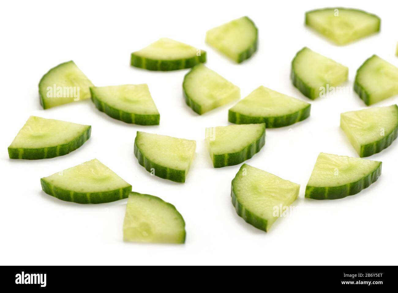 Cucumber quarter slices on white background Stock Photo - Alamy