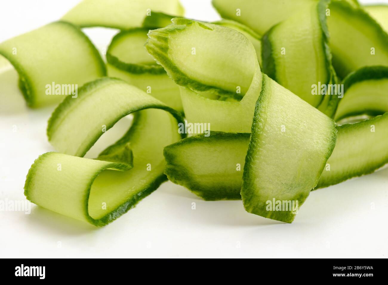Fresh cucumber ribbon peels on white background Stock Photo - Alamy