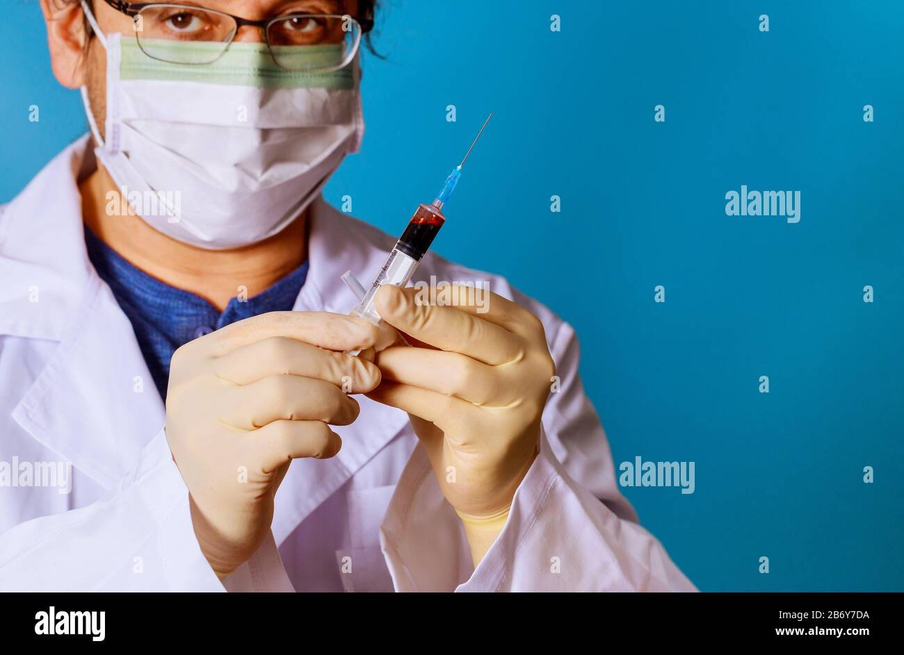 Hand of medical doctor holding syringe blood sample inside in the ...
