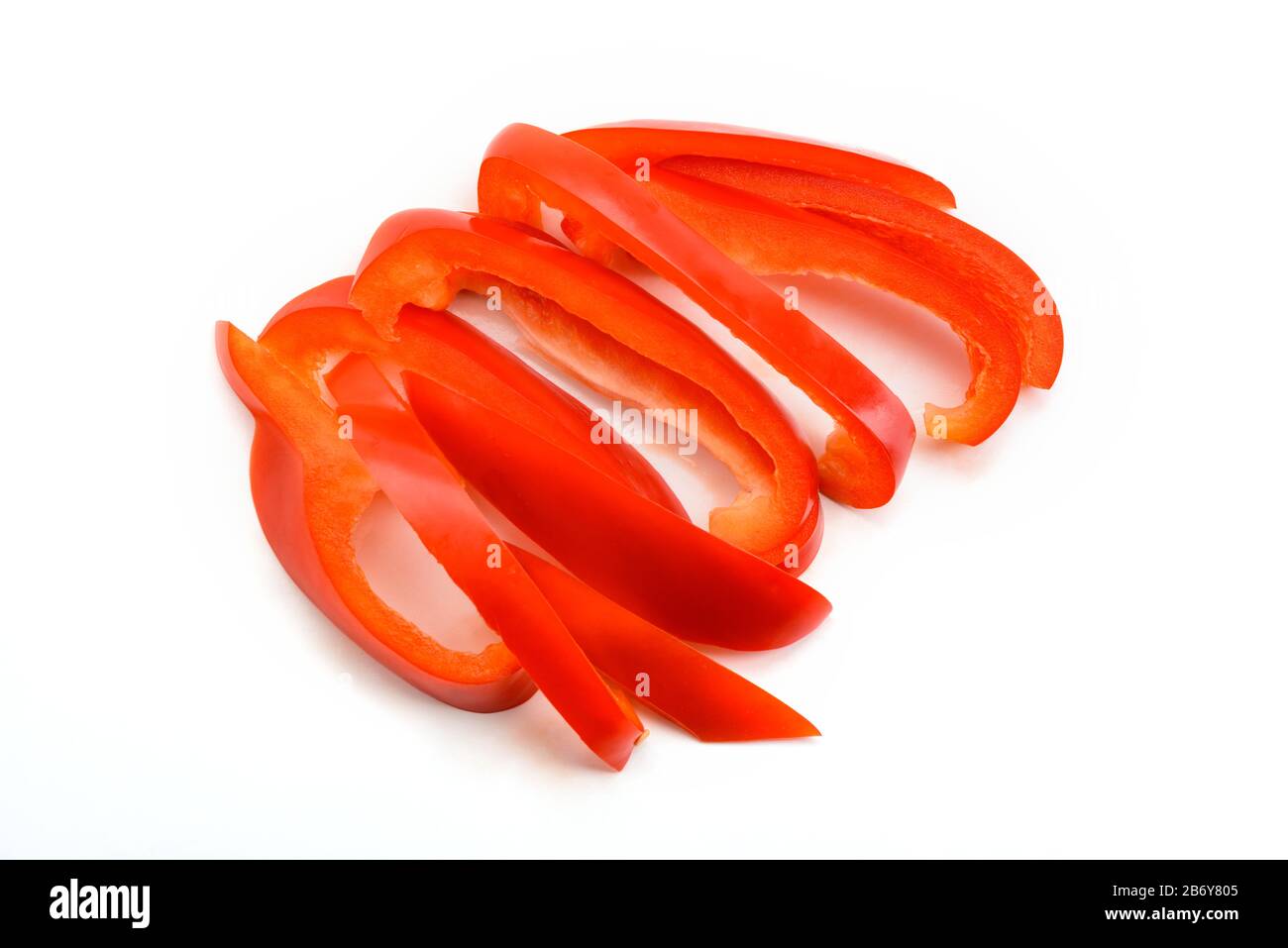 Red bell pepper cut into strips on white background Stock Photo - Alamy