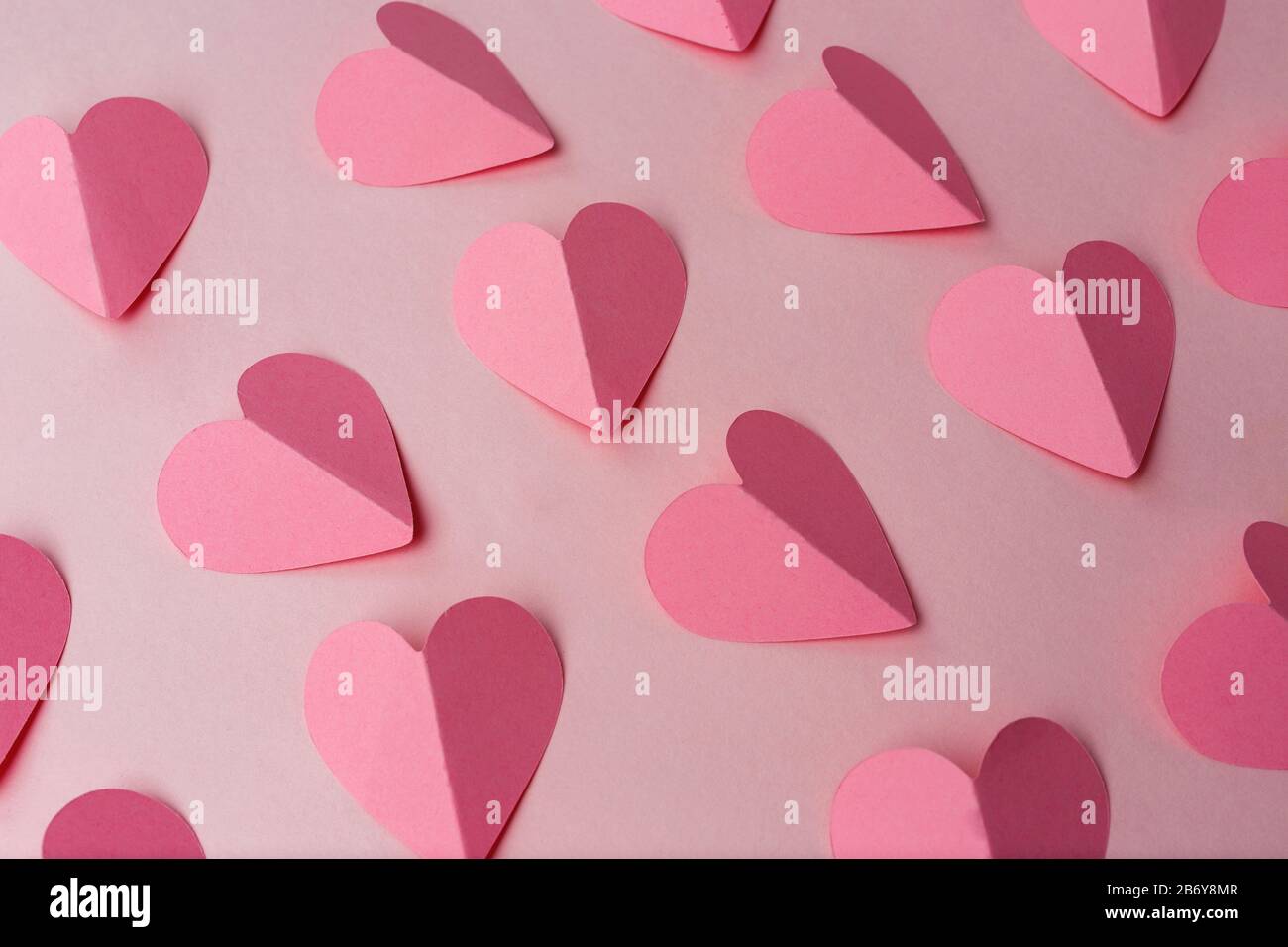 Pink paper hearts on pink background Stock Photo - Alamy
