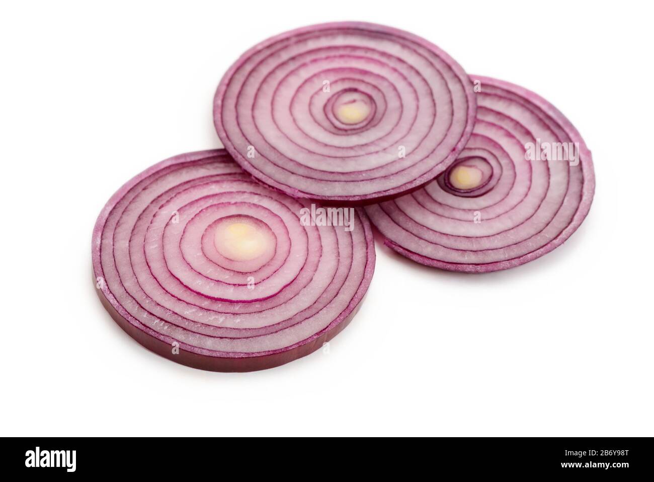 Few circle slices of red onion on white background Stock Photo - Alamy