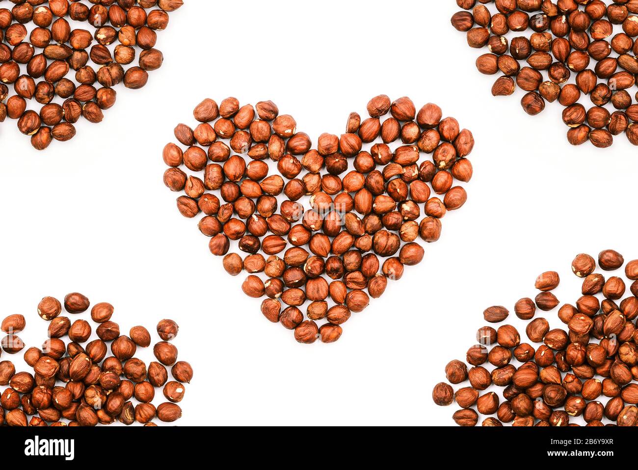 Heart shape made of hazelnuts on a white background. Brown walnut ... Heart shape made of hazelnuts on a white background. Brown walnut ...