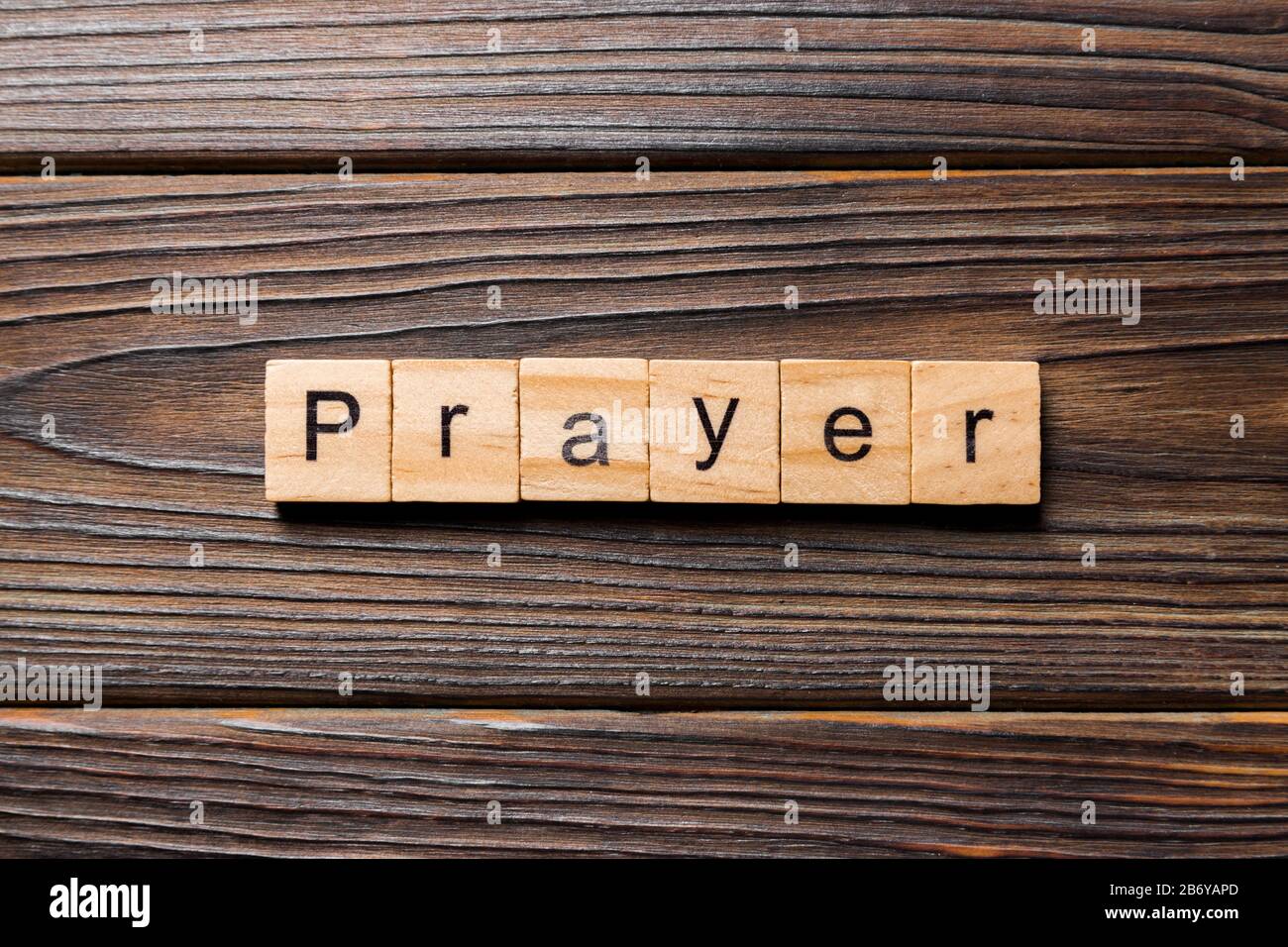 PRAYER word written on wood block. PRAYER text on wooden table for your ...