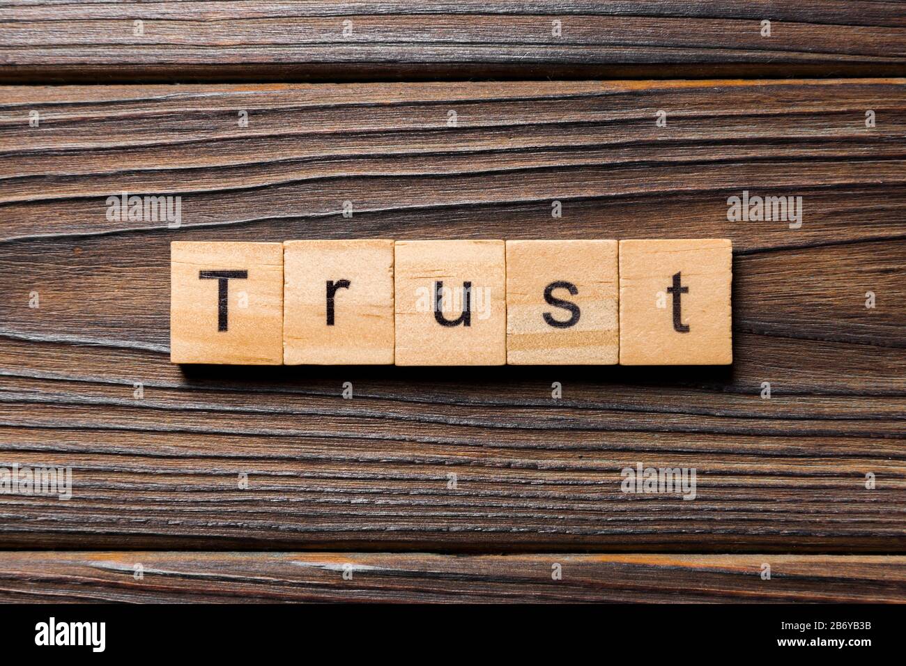 TRUST word written on wood block. TRUST text on table, concept Stock ...