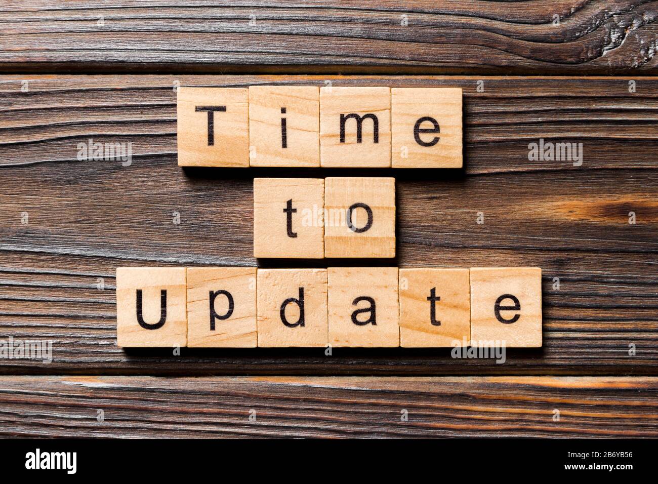 Time to update word written on wood block. Time to update text on ...