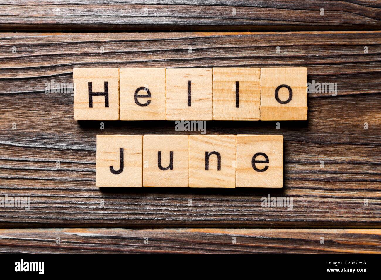 Hello June word written on wood block. Hello June text on table ...