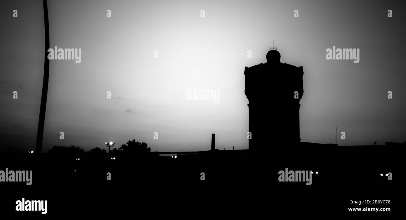 Black and white composition of wide view of a large tower at sunset ...