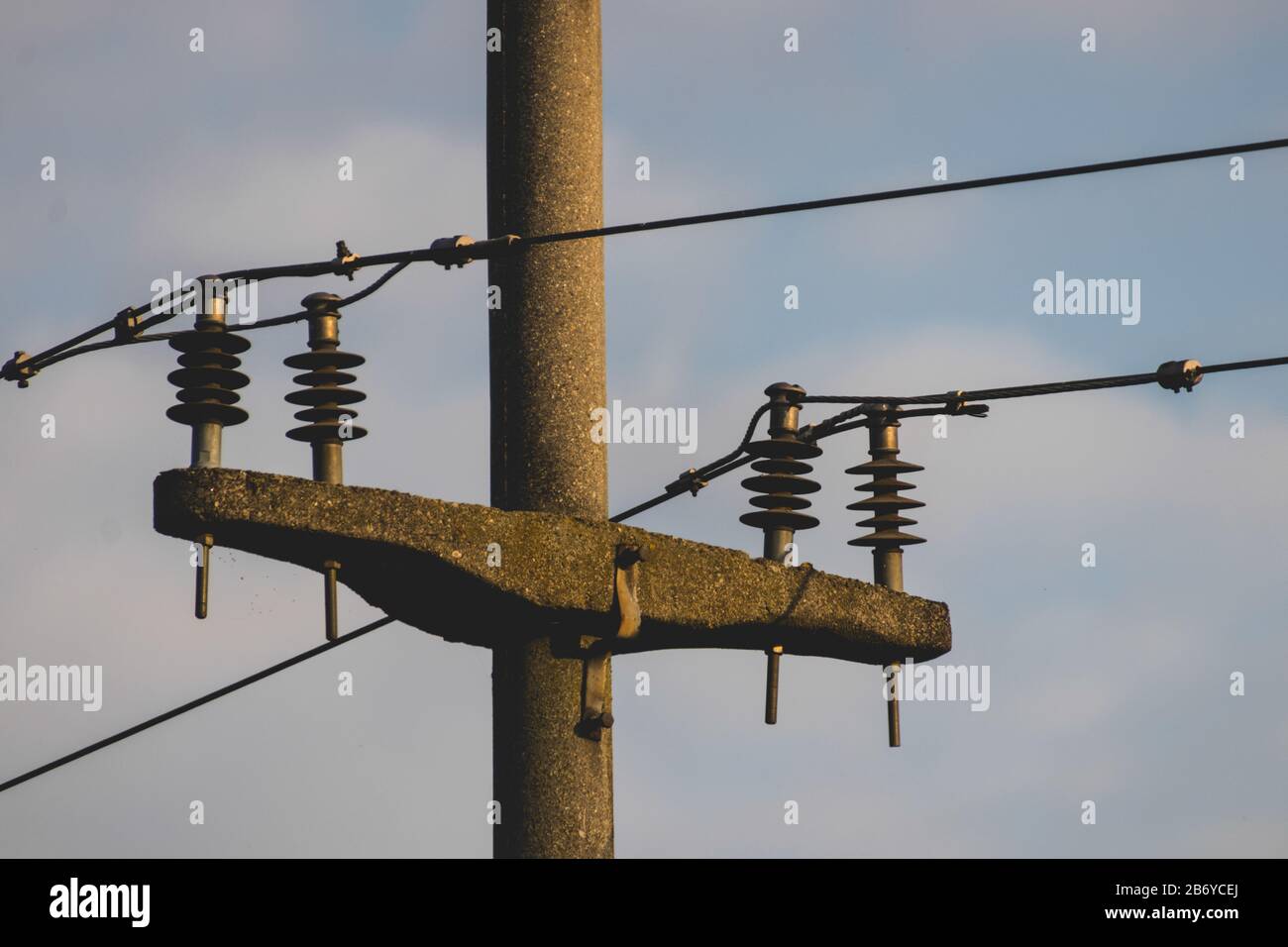 Closeup of power lines on power pole at sunset Stock Photo - Alamy