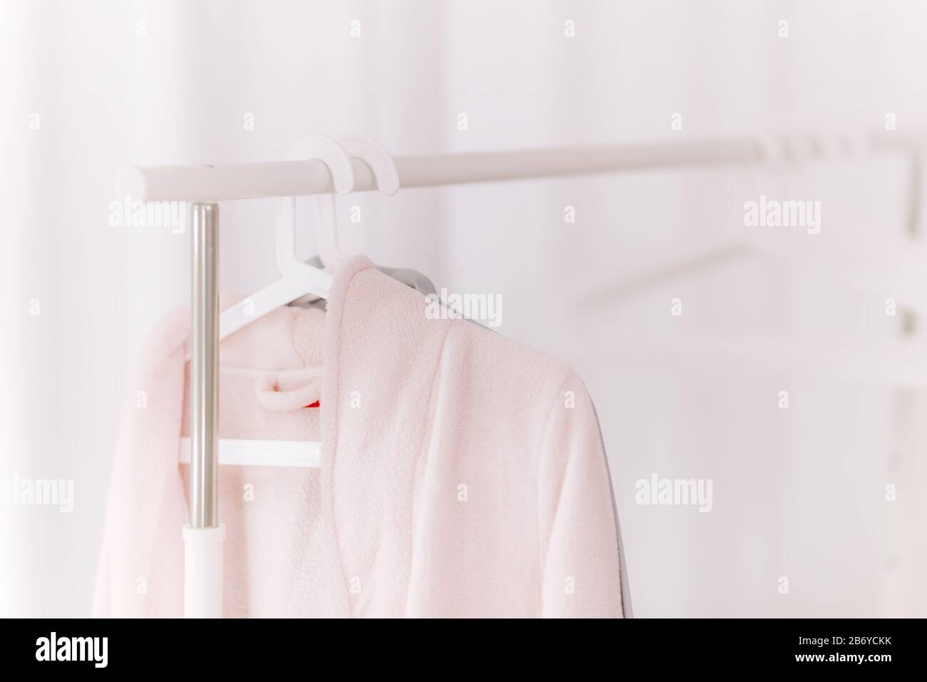 Stylish white hangers Stock Photo - Alamy