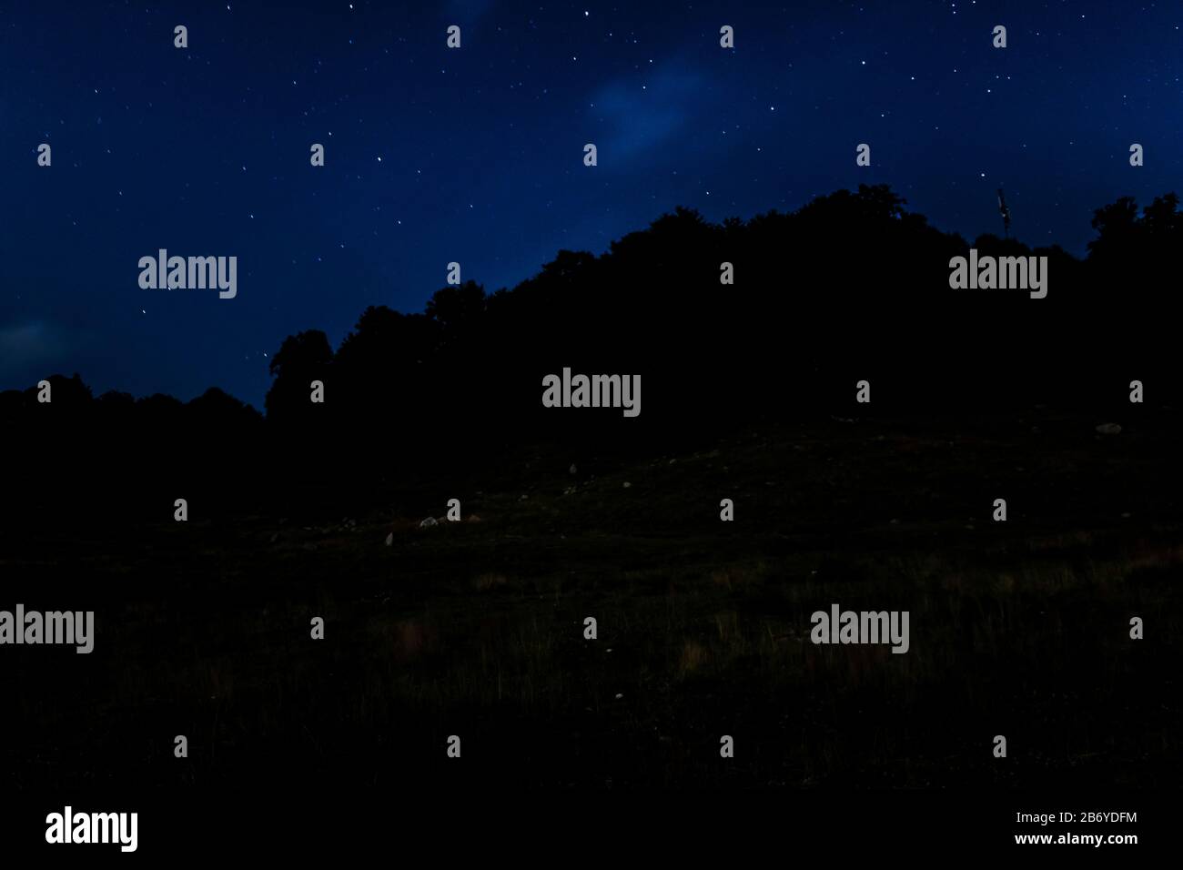 Starry night sky over hills Stock Photo - Alamy