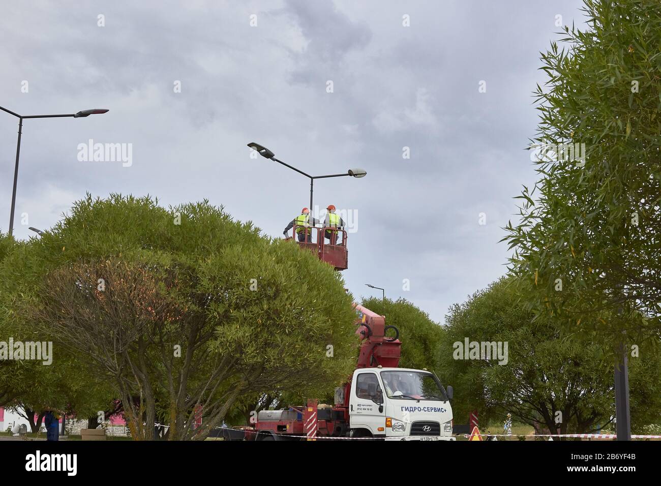 Saint Petersburg, RUSSIA - July 11, 2019: workers in lift bucket repair ...