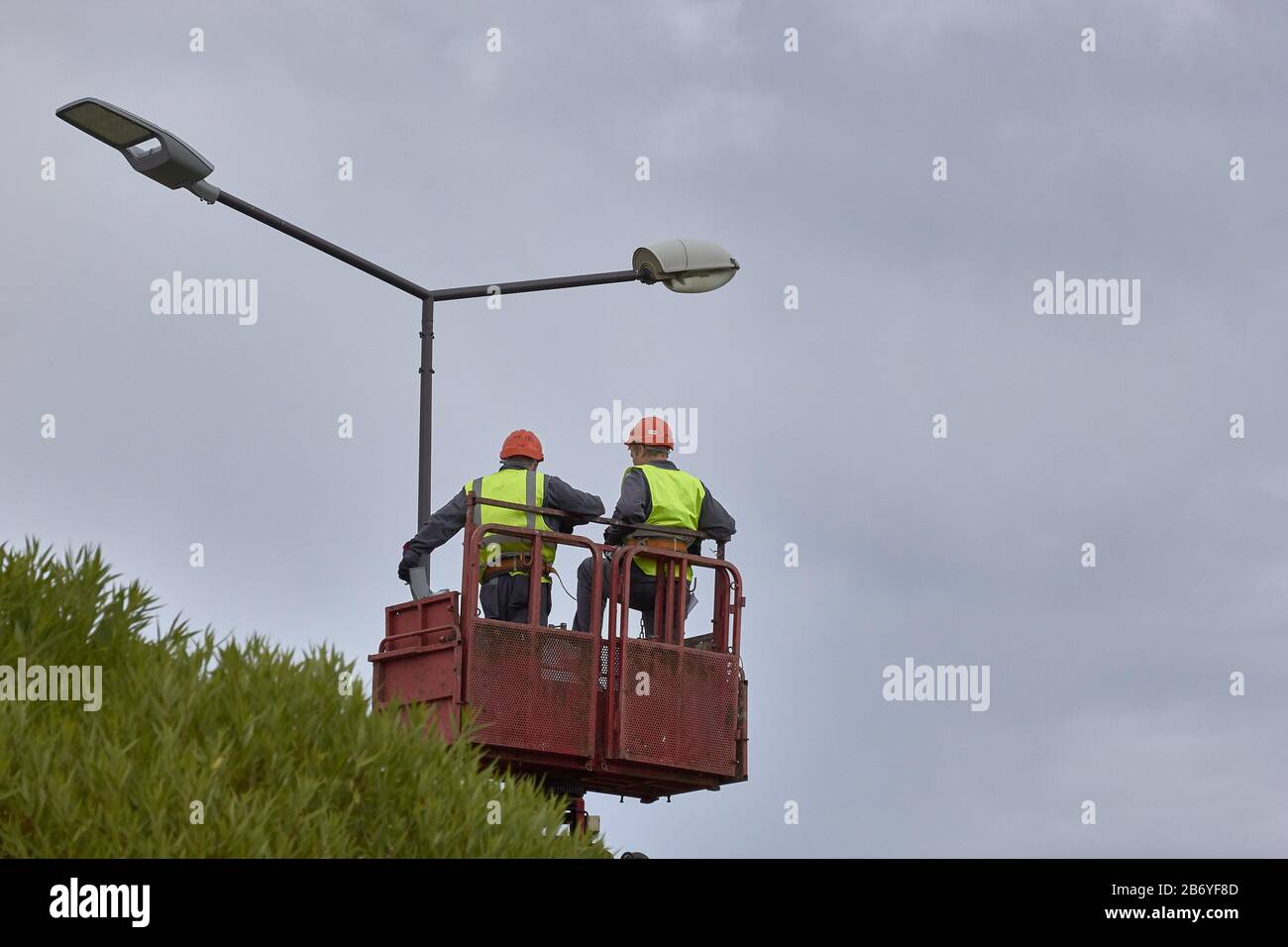 Saint Petersburg, RUSSIA - July 11, 2019: workers in lift bucket repair ...