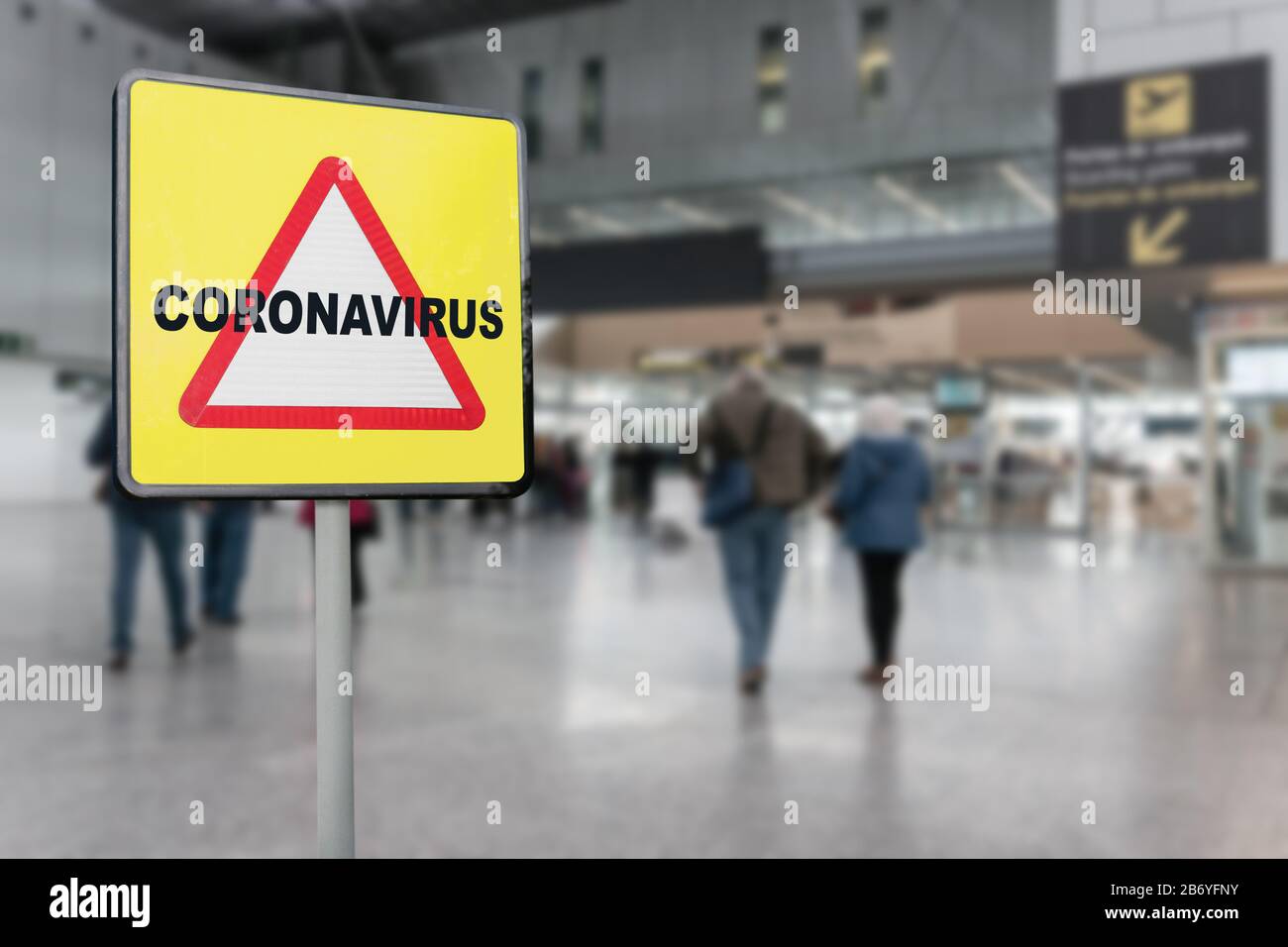 Warning sign with text Coronavirus on a generic terminal airport with ...