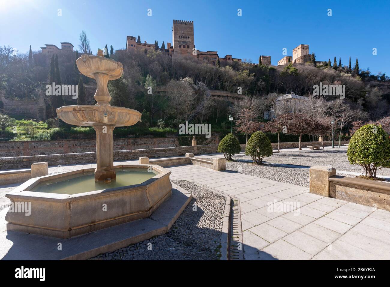 Alhambra Palace at the top and down the river Darro with a stone ...