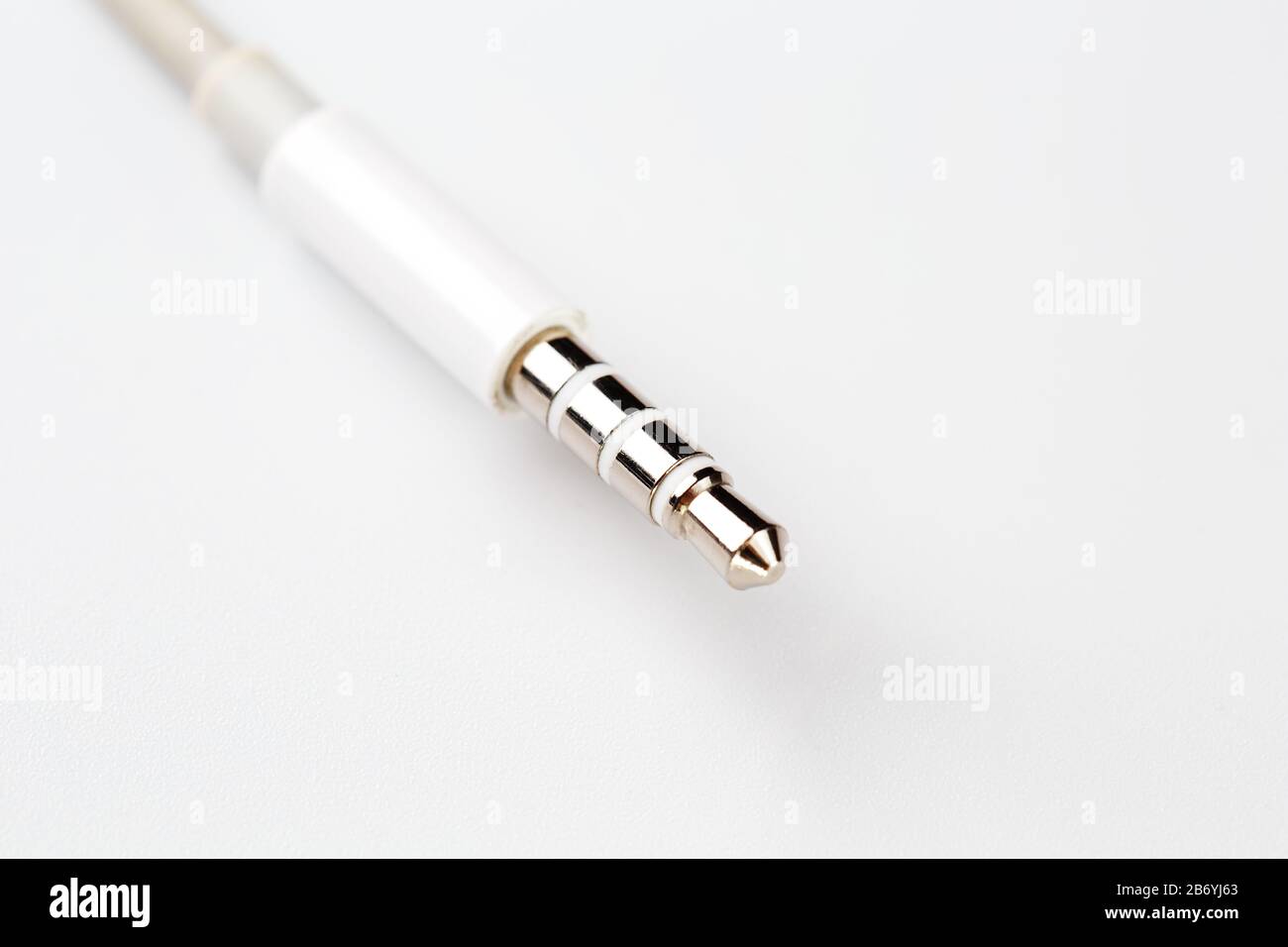 Isolated white aux cable on white background Stock Photo - Alamy