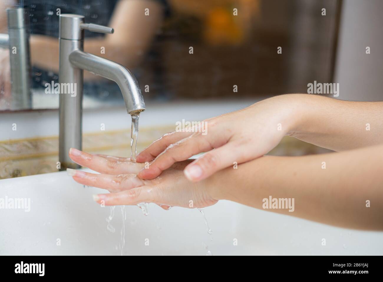 The beautiful female hand that applying soap in the sink from or anti ...