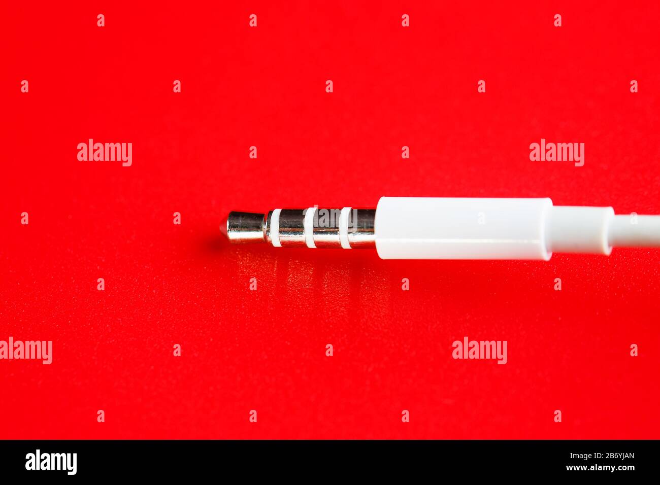 White connector auxiliary white cable on a red background Stock Photo ...