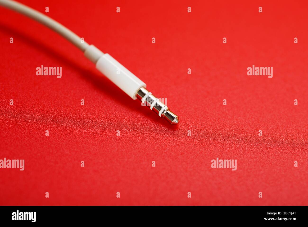White connector auxiliary white cable on a red background Stock Photo ...