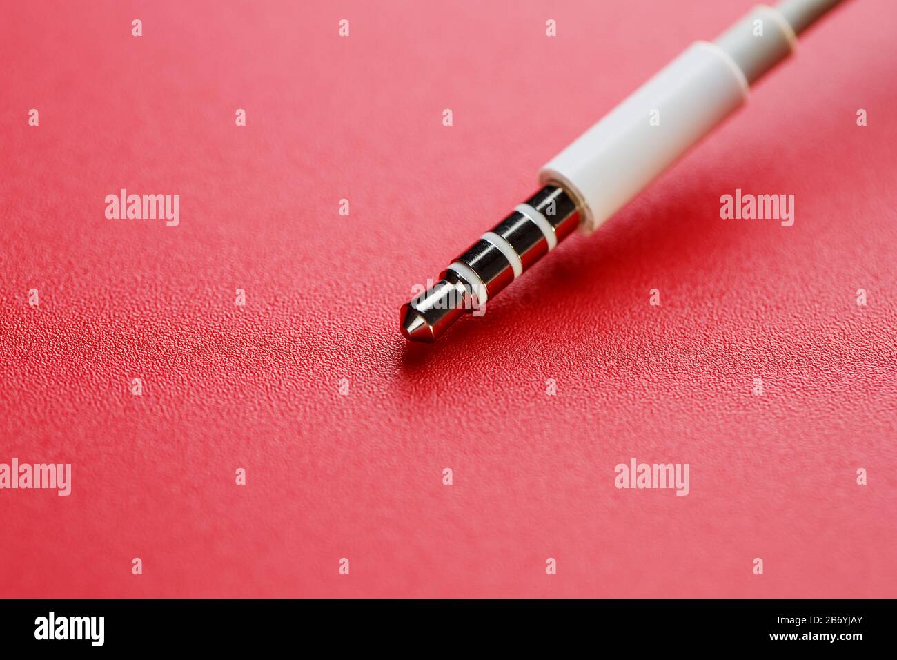 White connector auxiliary white cable on a red background Stock Photo ...