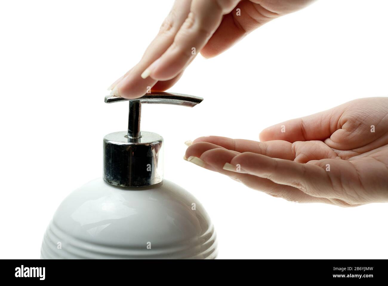 Close up woman hand press pumping lotion from the bottle a whip liquid ...