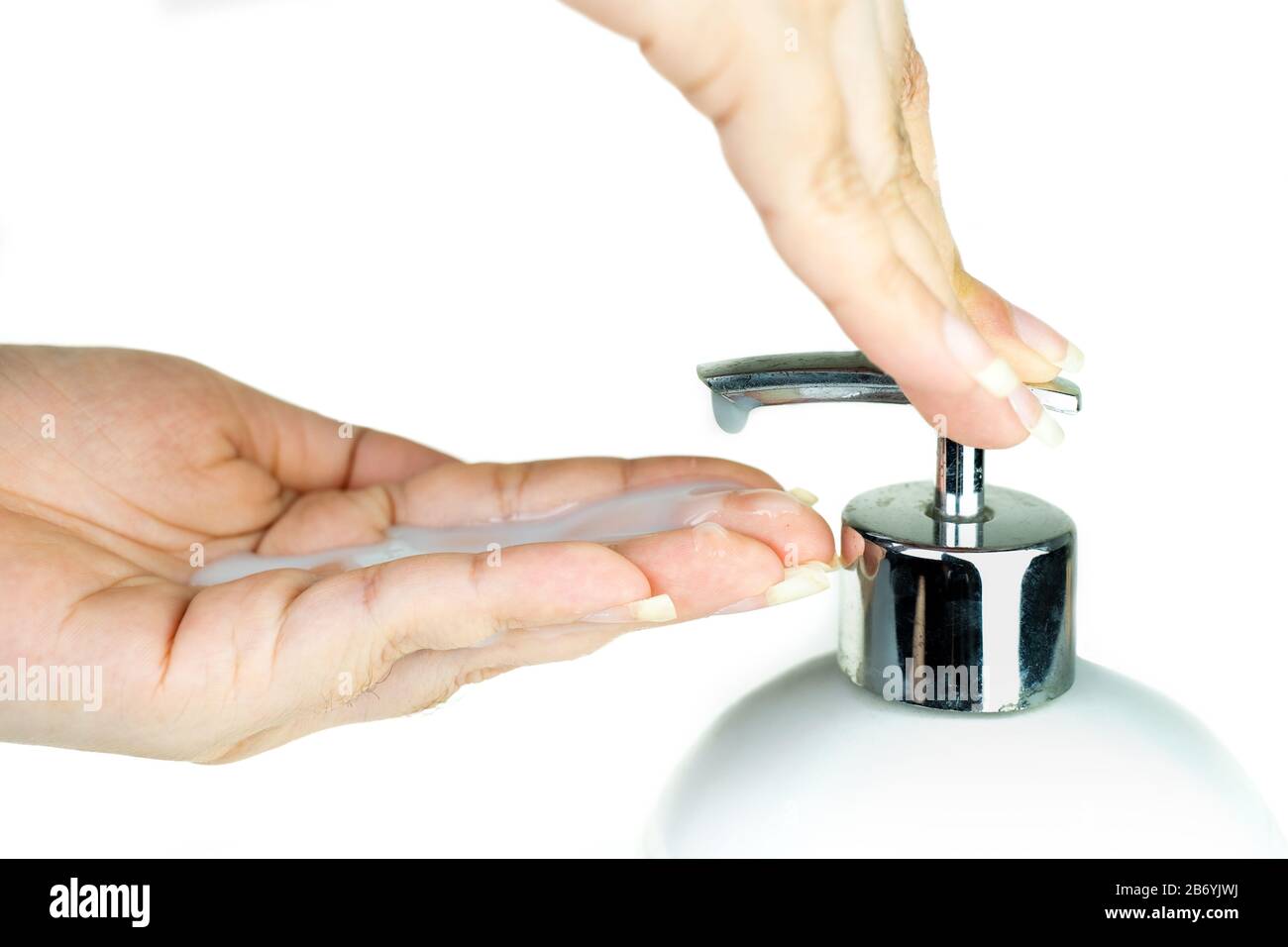 Woman hand pumping lotion from the bottle a whip liquid soap at white ...