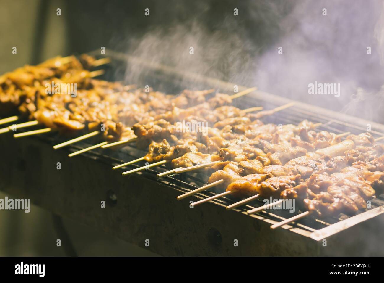 Chicken chunks skewers, grill, barbecue. On a metal bbq. In the ...
