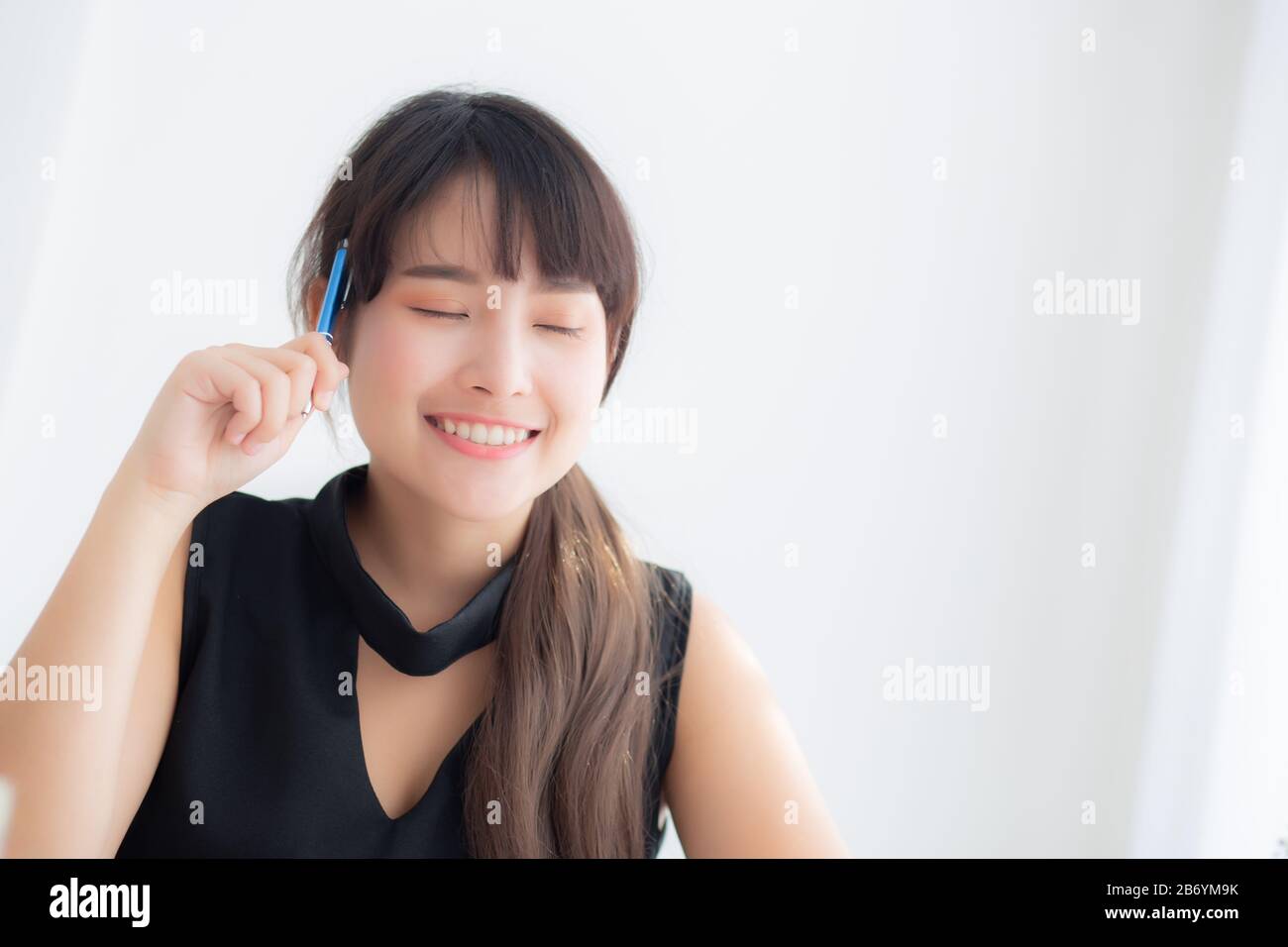 Beautiful asian woman writer smiling thinking idea and writing on ...
