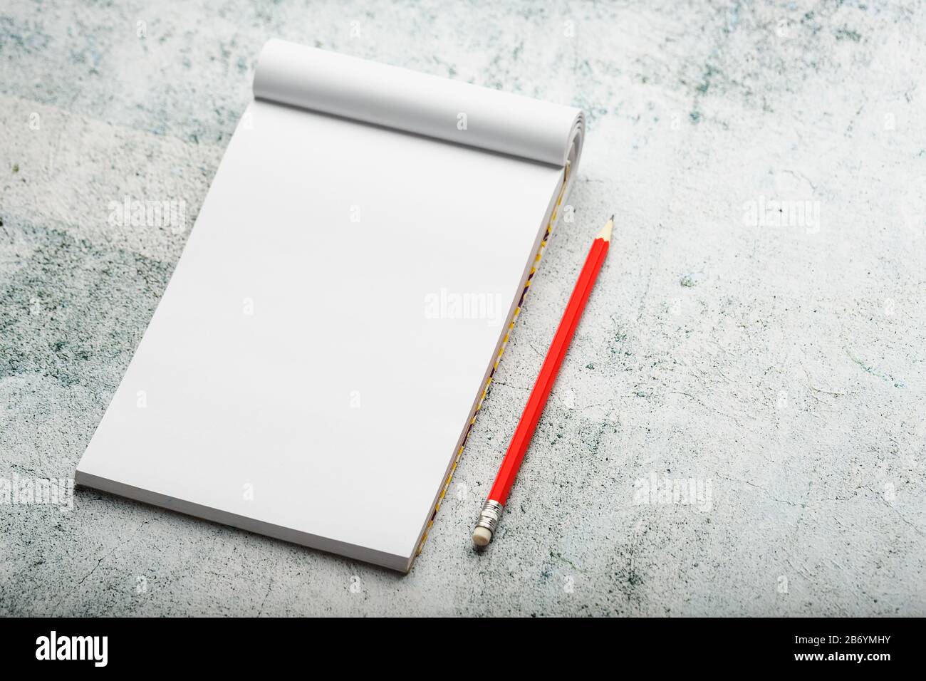 Notepad with a red pencil on a light background for writing. Free empty ...