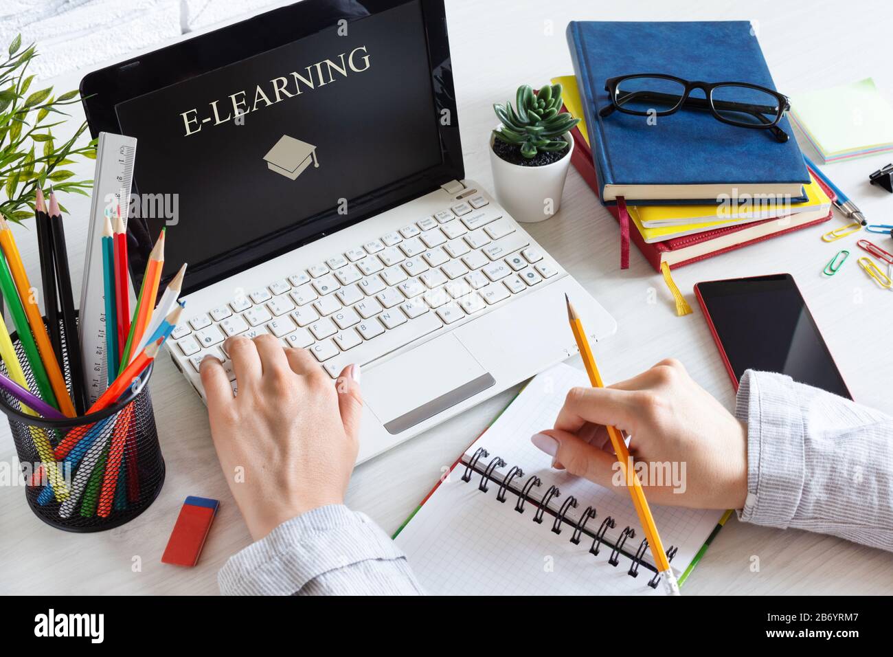 Woman hands using laptop. Workplace with computer and books. E-learning ...