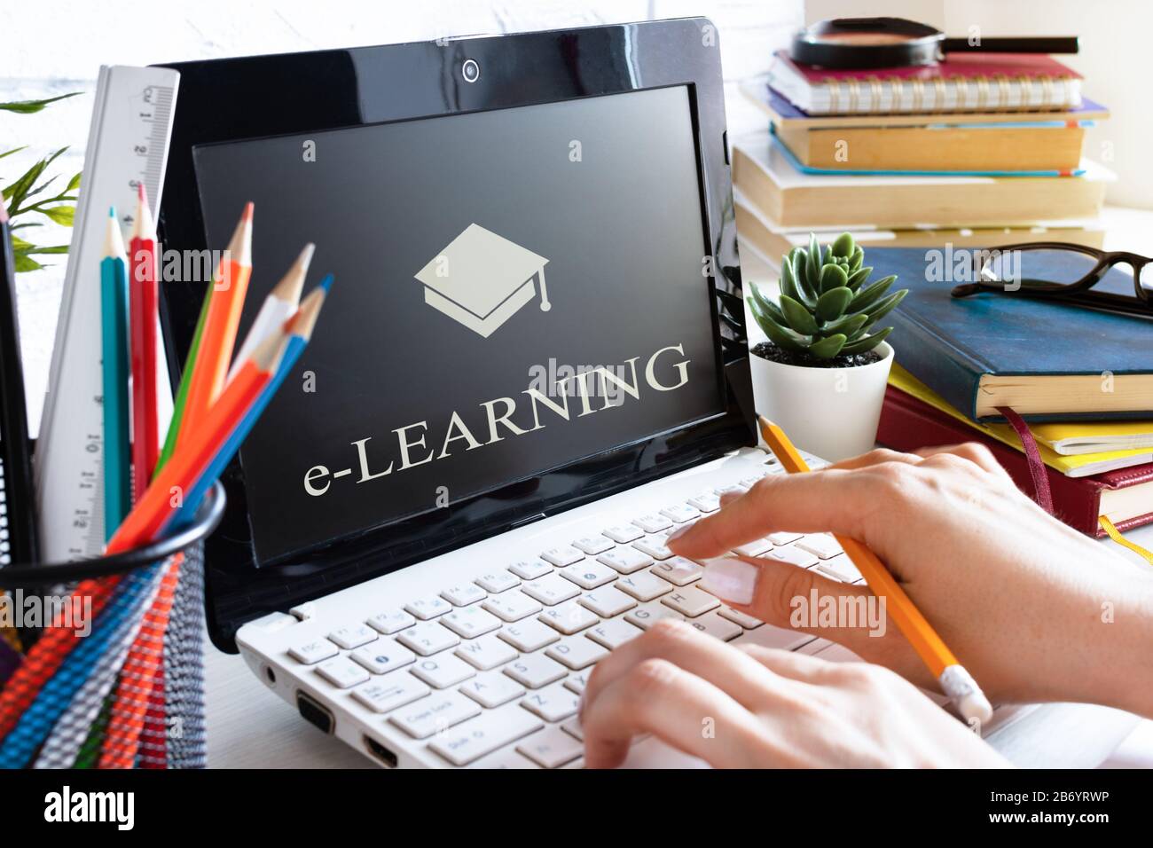 Woman hands using laptop. Workplace with computer and books. E-learning ...