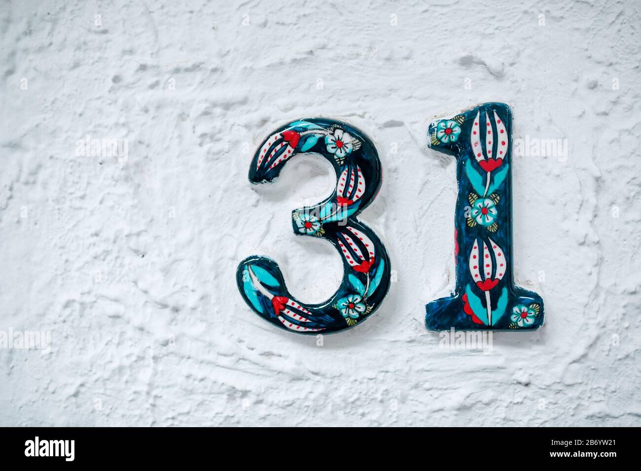 The number 31 is the house number on the white ceramic wall. Old ...