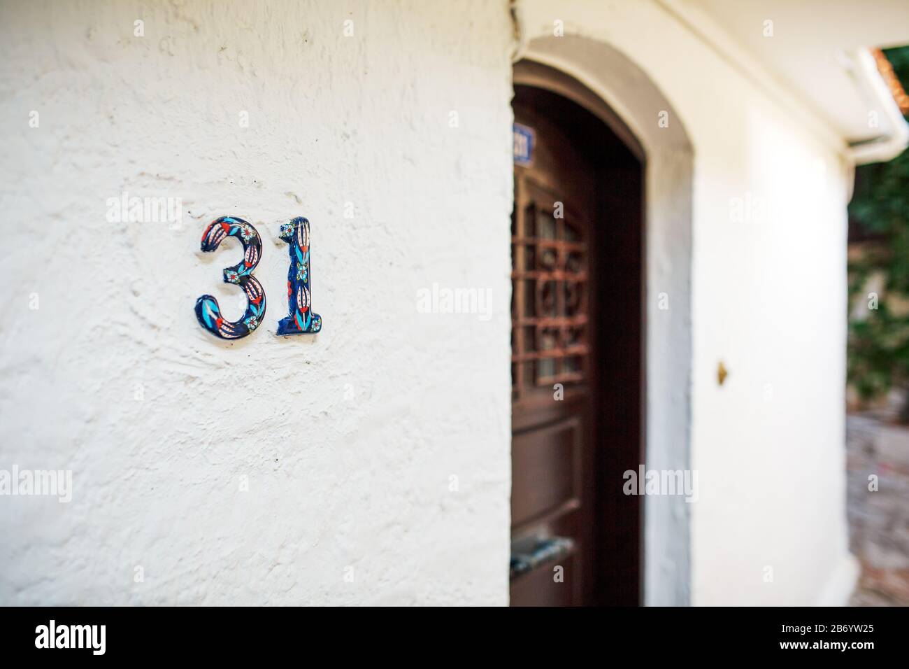 The number 31 is the house number on the white ceramic wall. Old ...