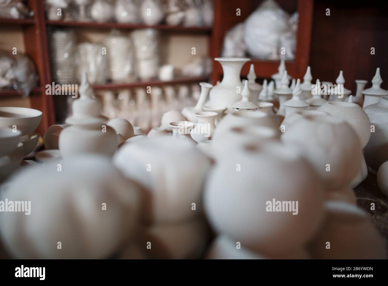 Making ceramic pots and cups from white clay handmade. Small family ...