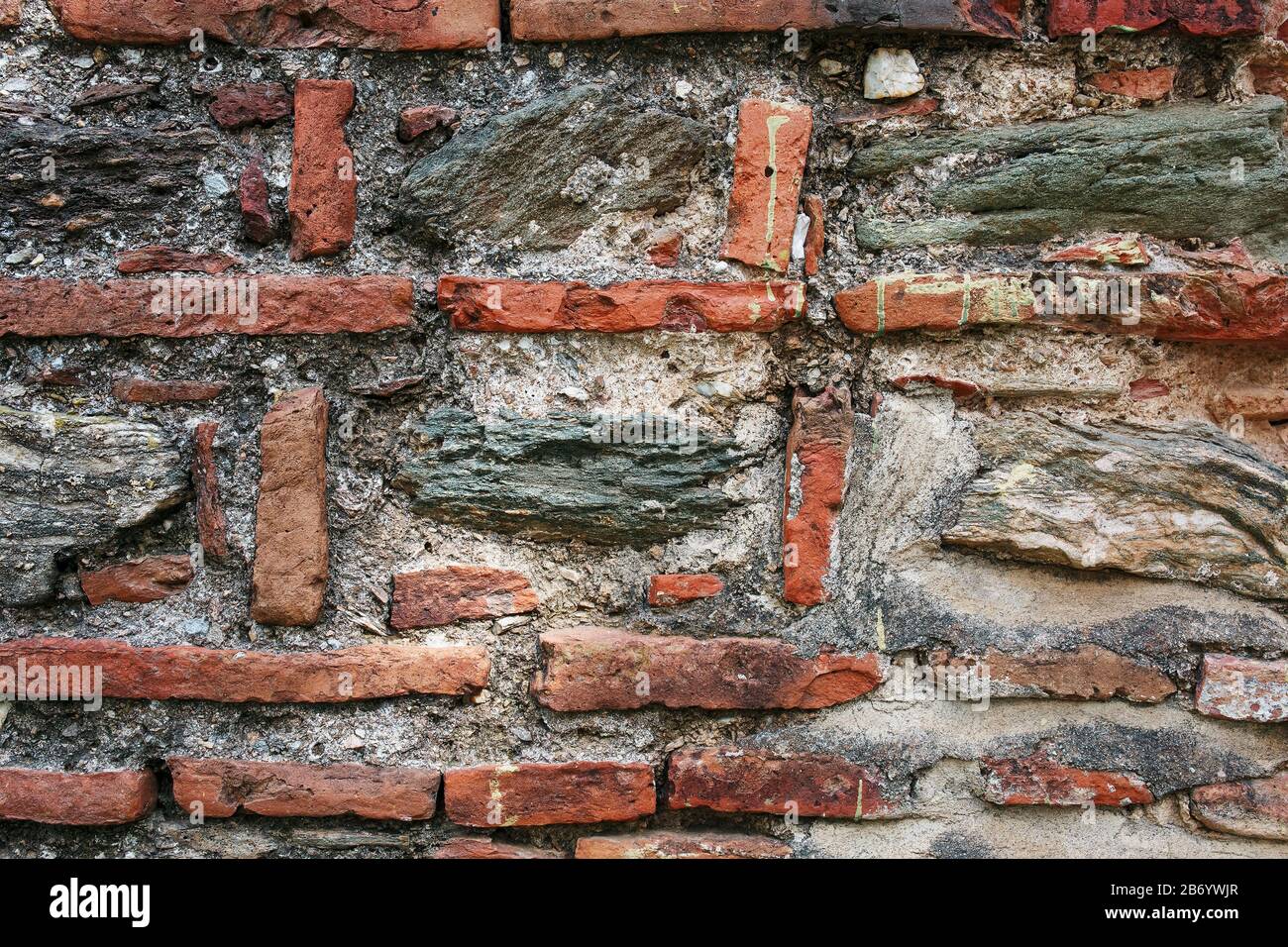 Antique gray stone wall framed by red brick. Turkish masonry. Full ...
