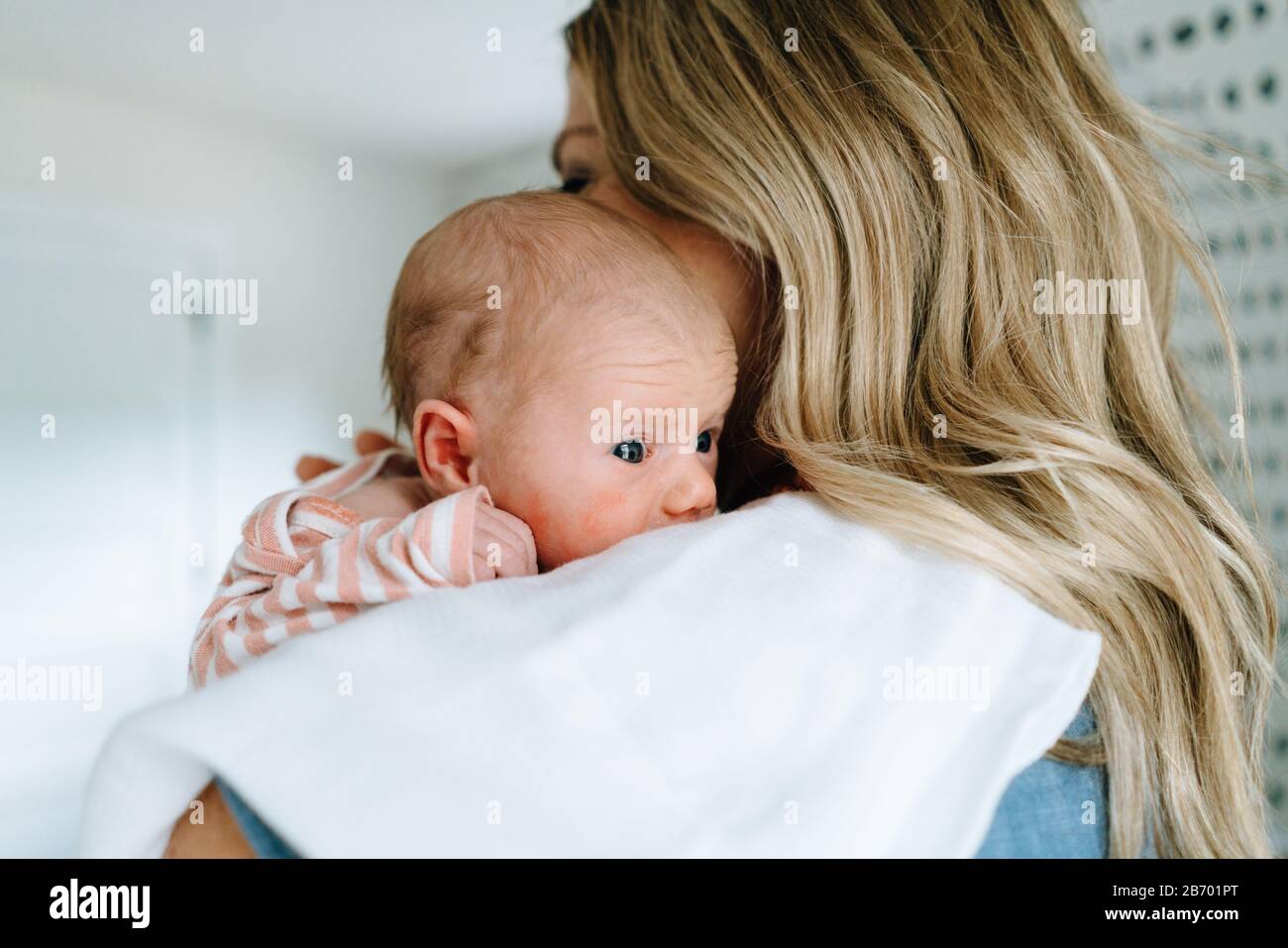 Closeup portrait of a newborn baby girl being held by her mother Stock ...