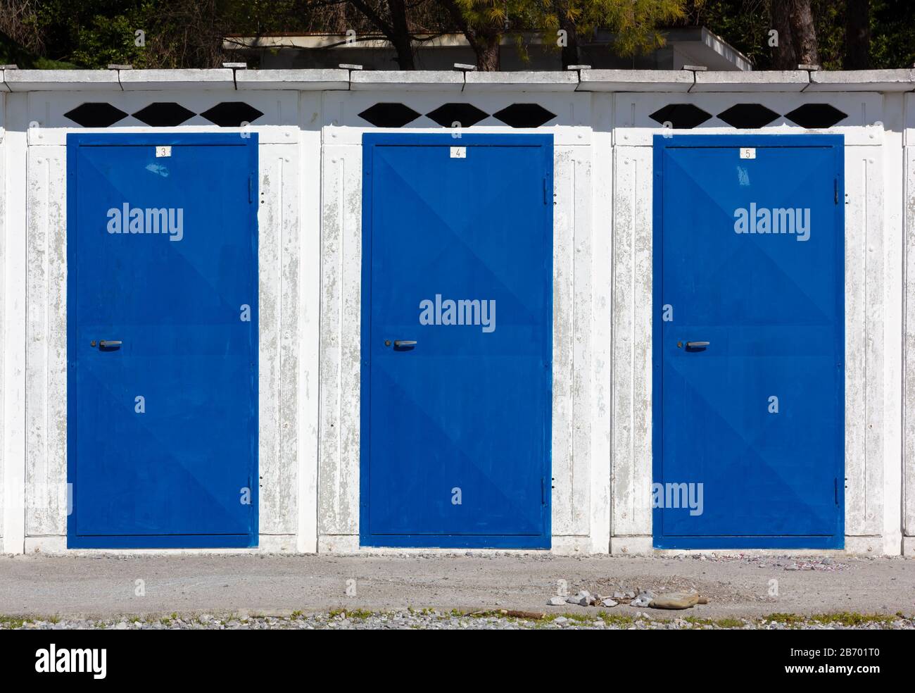Front view of three beach changing cabins with blue doors Stock Photo ...