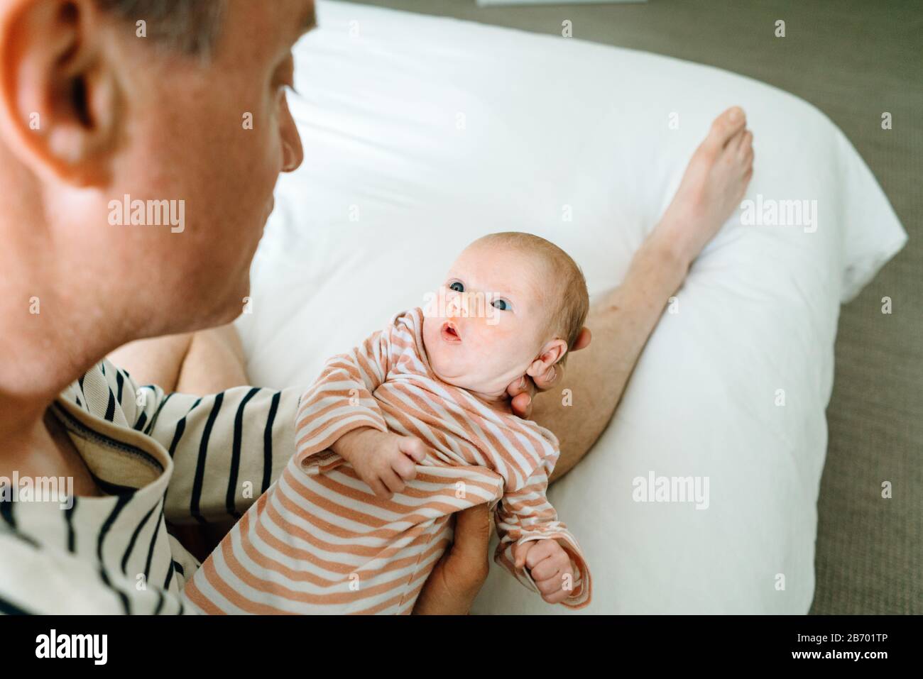 View from above of a newborn baby girl being held by her father Stock ...