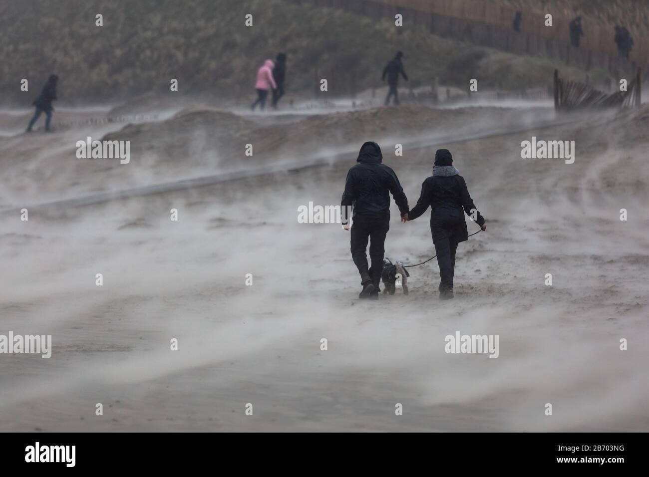 picture of people at the beach during a strong storm Stock Photo - Alamy