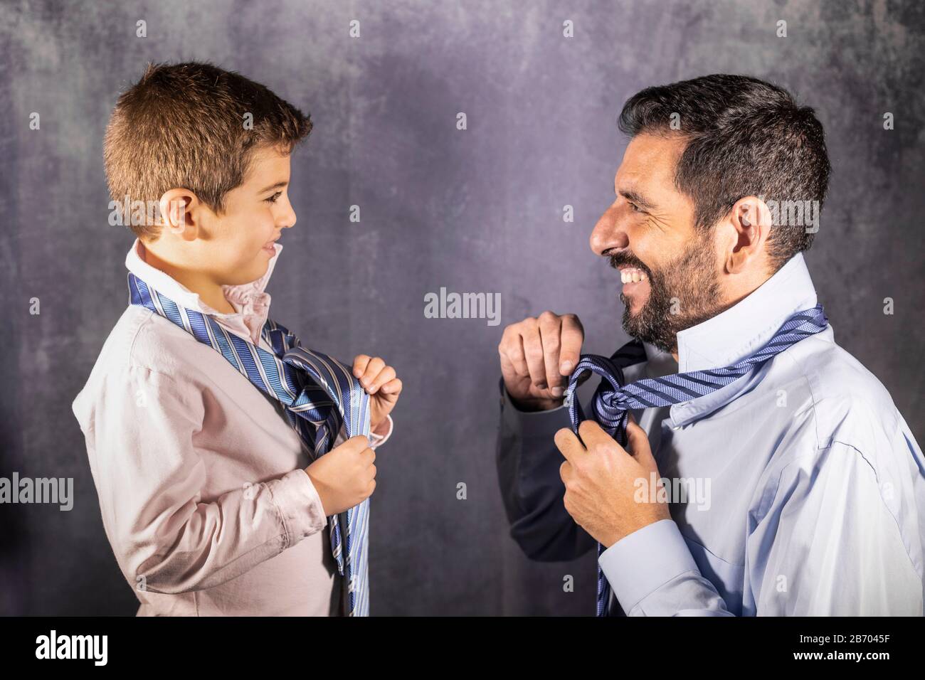 Father teaching his son to wear a tie Stock Photo - Alamy