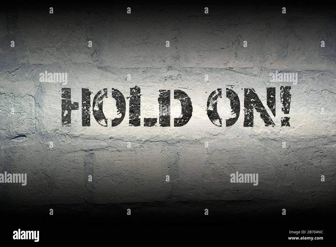 hold on exclamation stencil print on the grunge white brick wall Stock ...